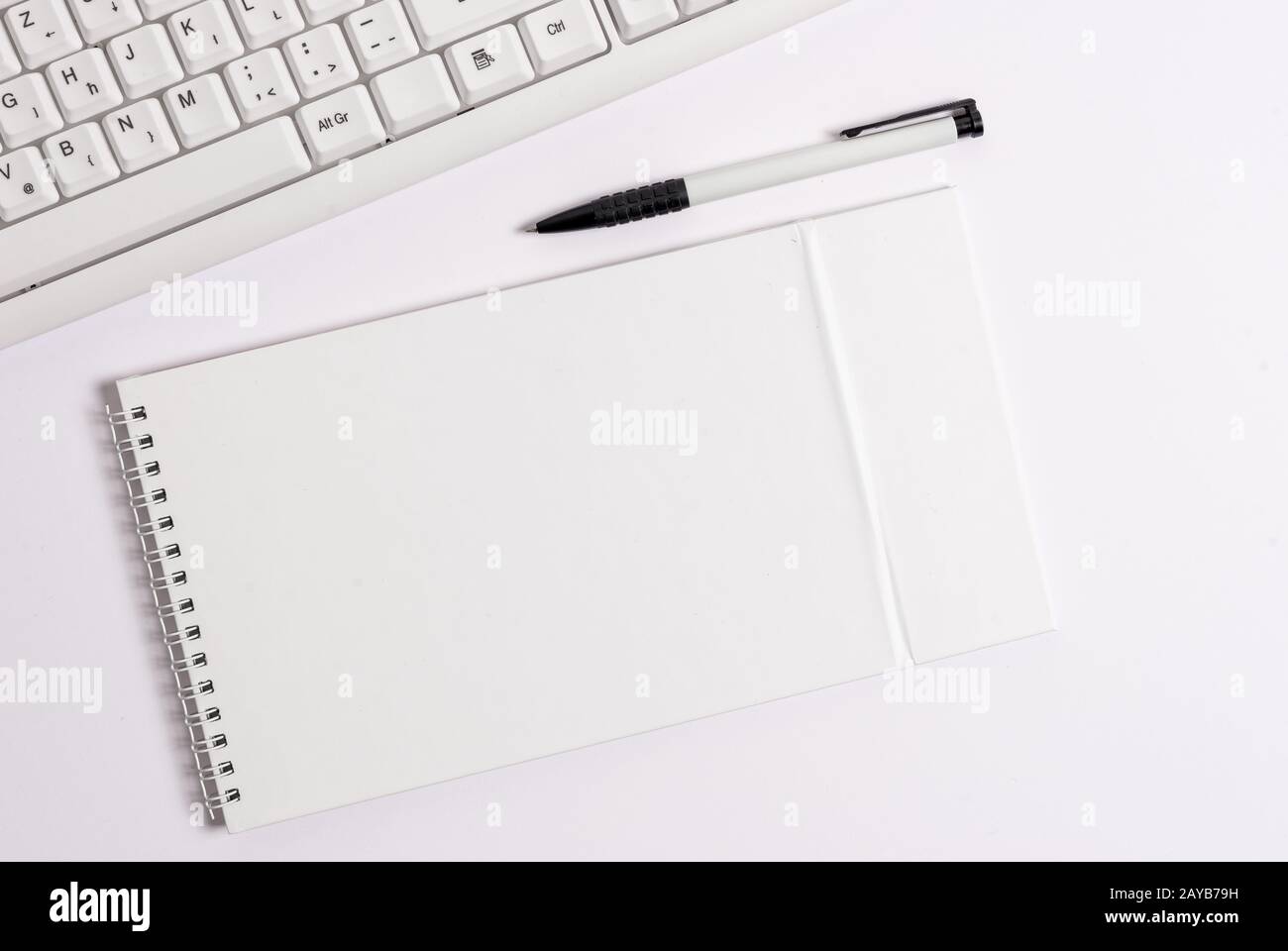 Business concept with notes and pc keyboard. White pc keyboard with ...