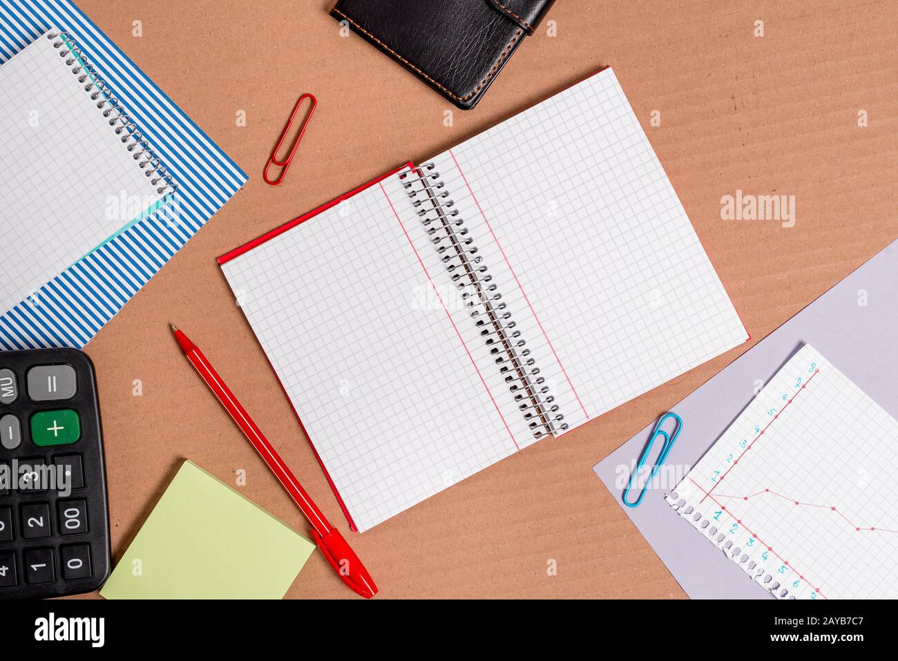 Cardboard desk with a striped blue sheet, notebook paper and office ...