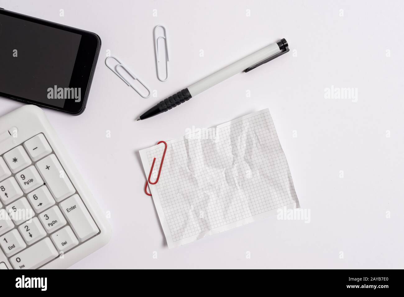 Blank paper space for textual message. White pc keyboard with empty ...