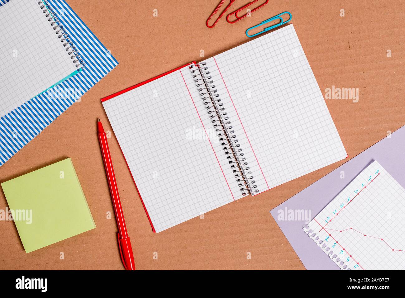 Cardboard desk with a striped blue sheet, notebook paper and office ...