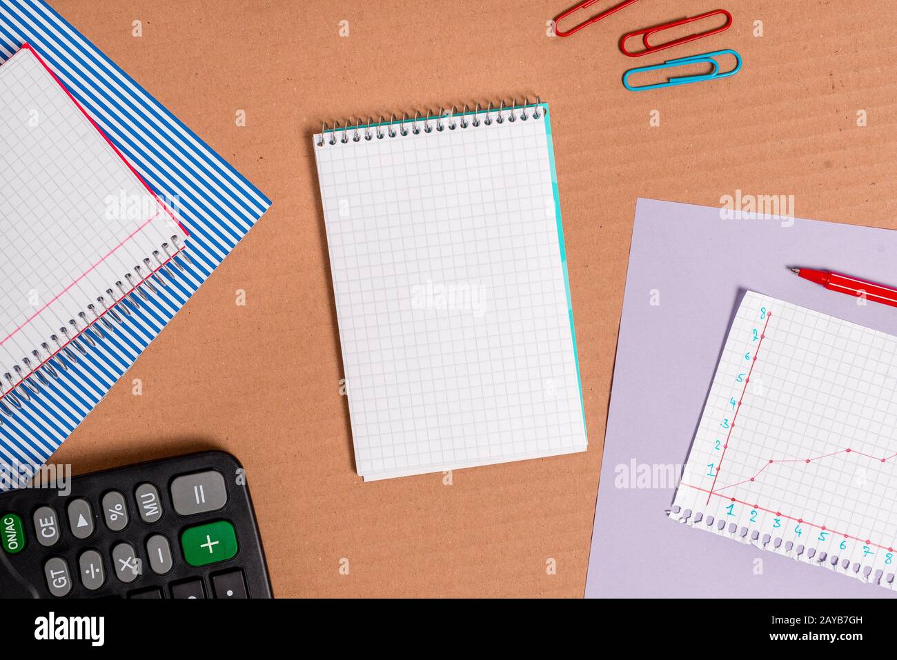 Cardboard desk with a striped blue sheet, notebook paper and office ...