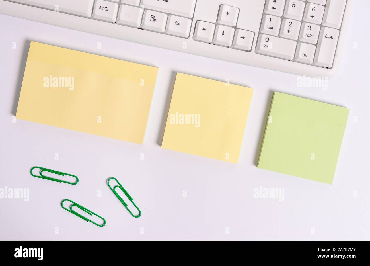 Sticky note paper on the table with pc keyboard. Flat lay above blank ...