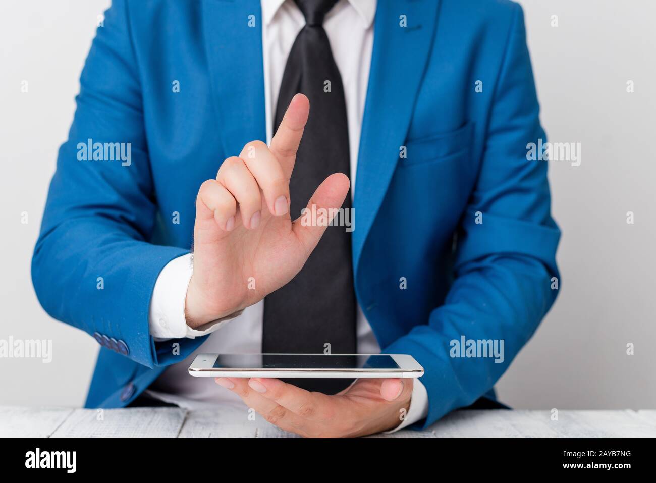 Businessman with pointing finger in front of him. Businessman holds lap ...