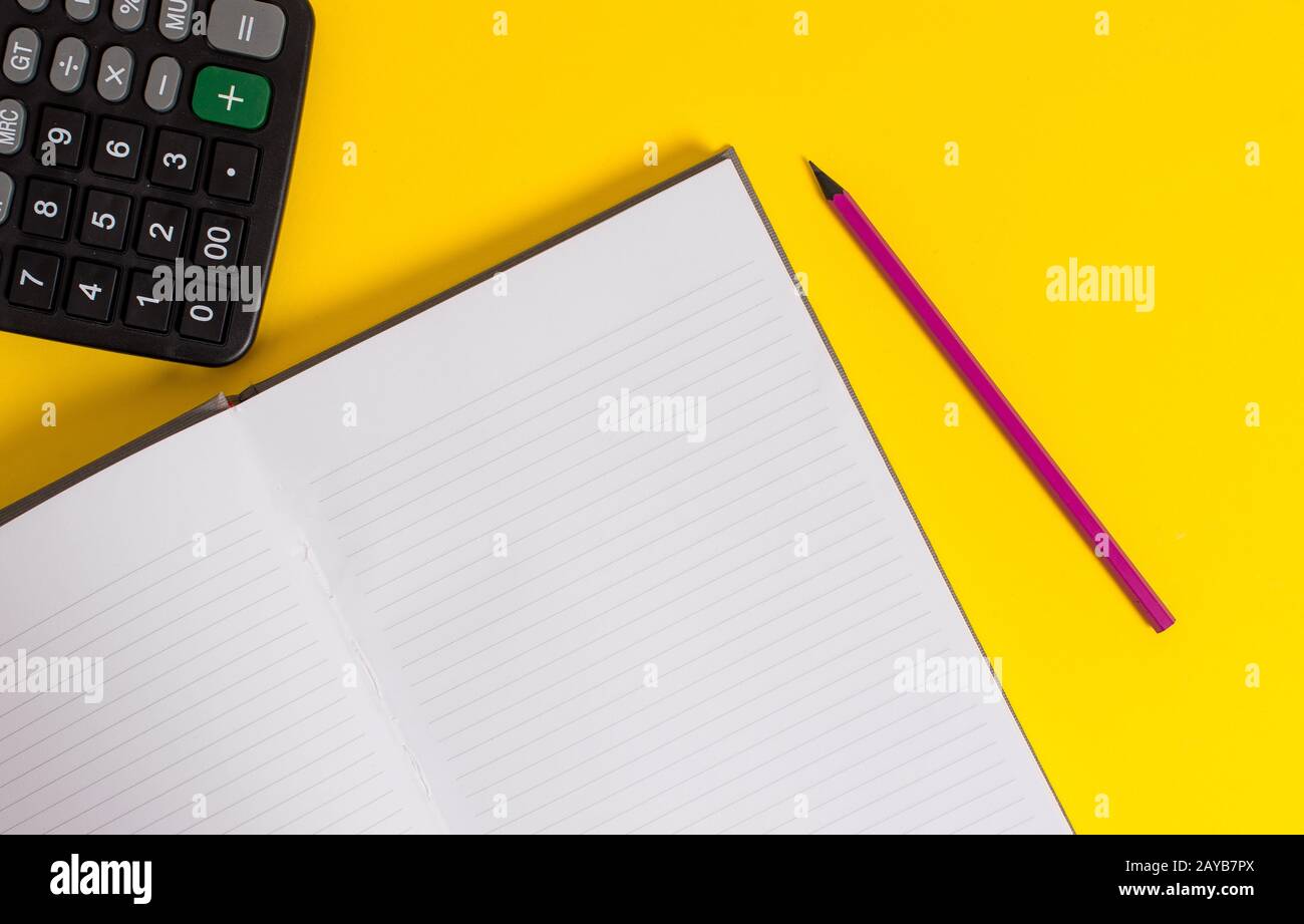 Front view open striped hard cover notebook lying pencil marker ...