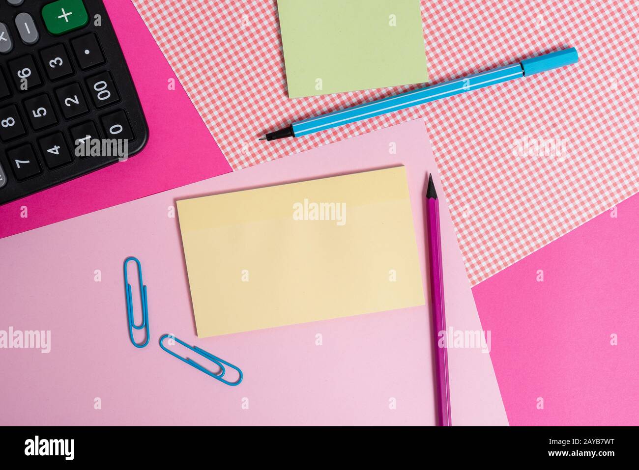 Stationary and notation papers placed above coloured backdrop. Writing ...