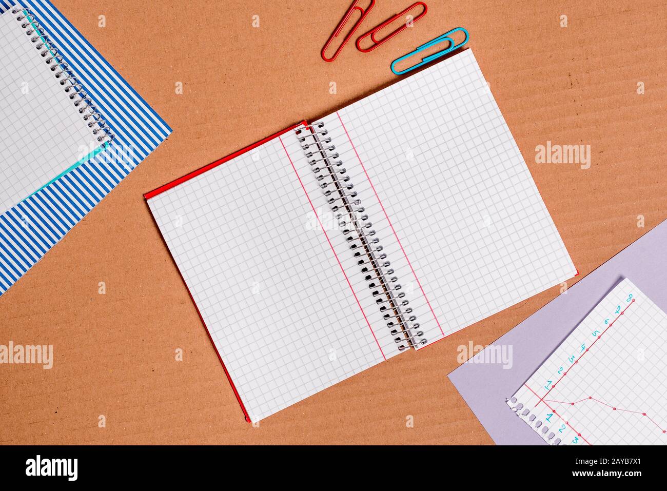 Cardboard desk with a striped blue sheet, notebook paper and office ...