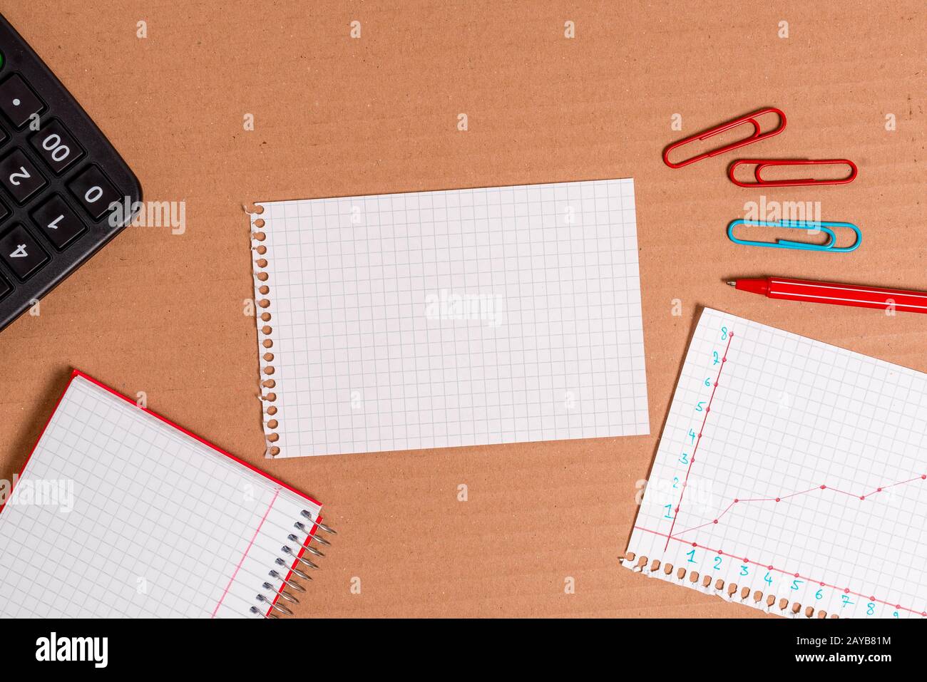 Cardboard desk with notebook paper and office appliances. Paperboard ...