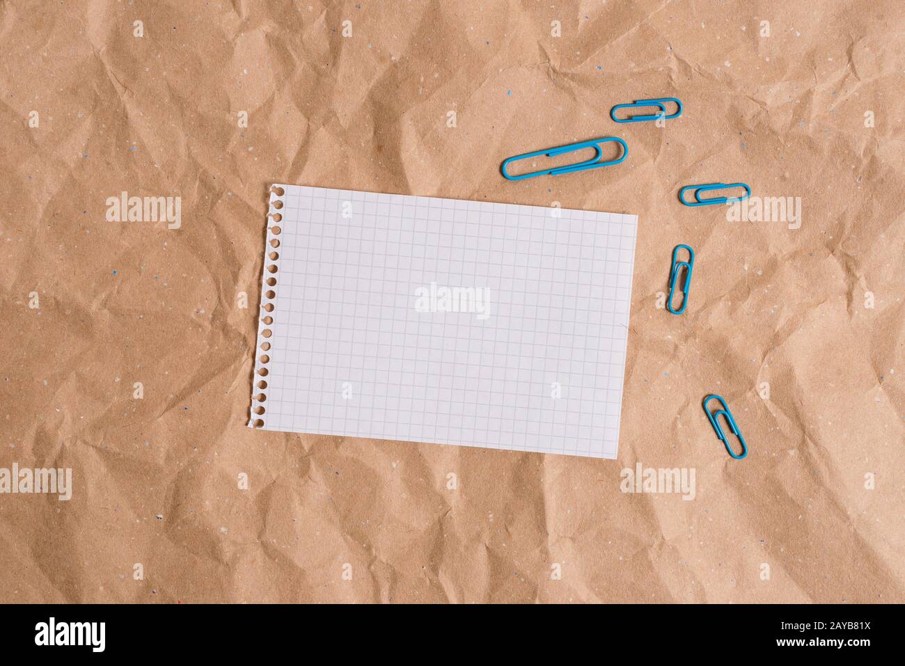 Desk made of crumpled cardboard with different types and sizes of empty paper. Papercraft table ...