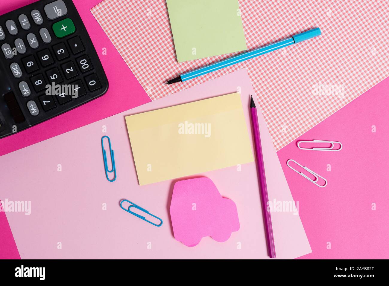 Stationary and notation papers placed above coloured backdrop. Writing ...