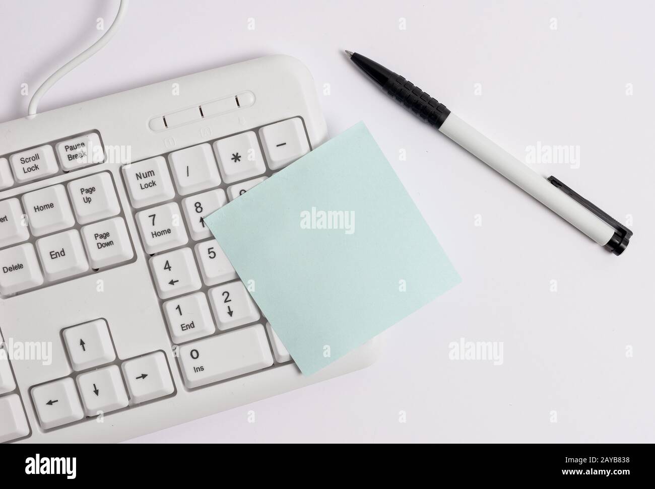 Blank paper space for textual message. White pc keyboard with empty ...