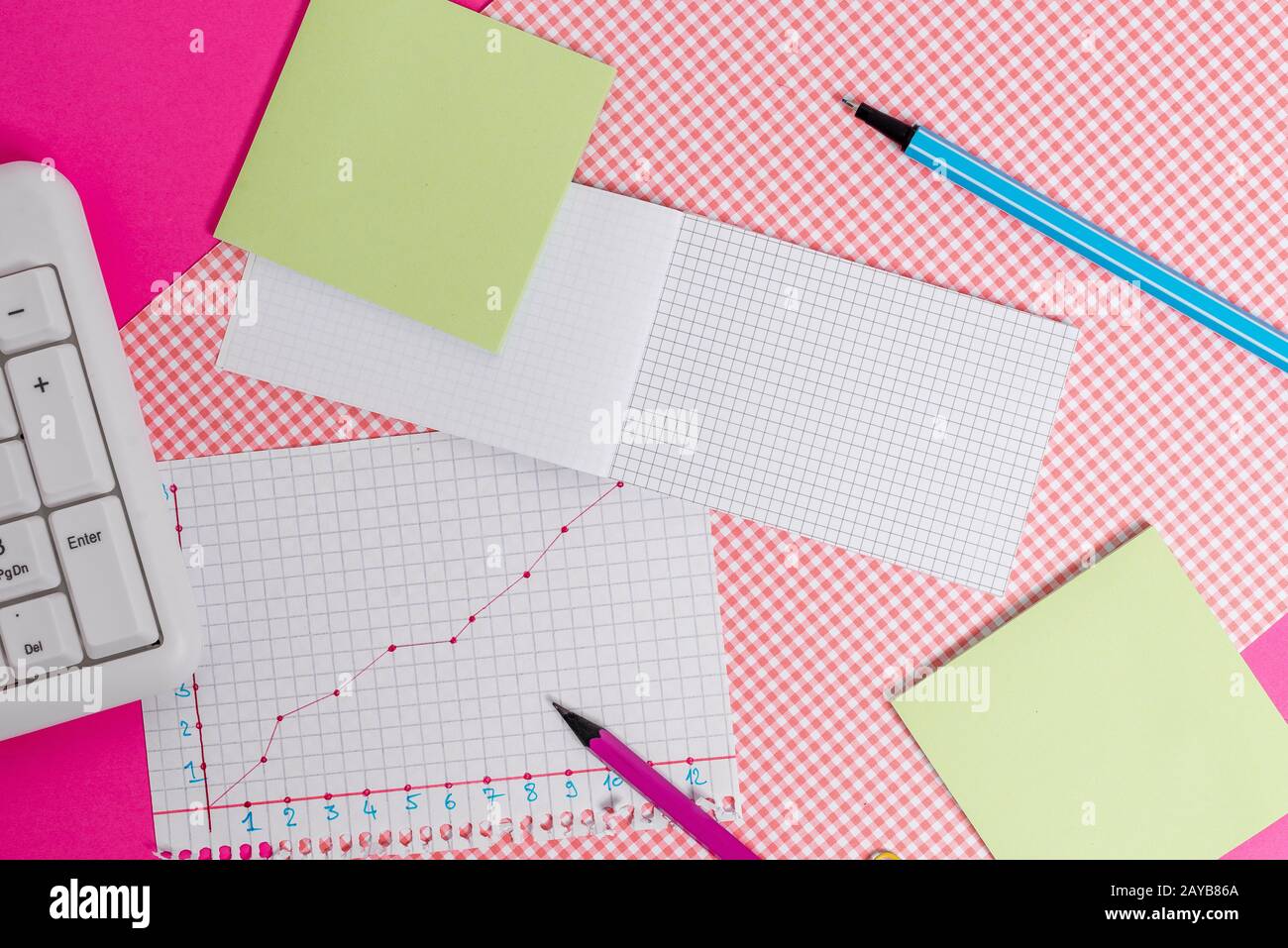 Writing equipments and computer stuffs plus mathematic paper placed on ...