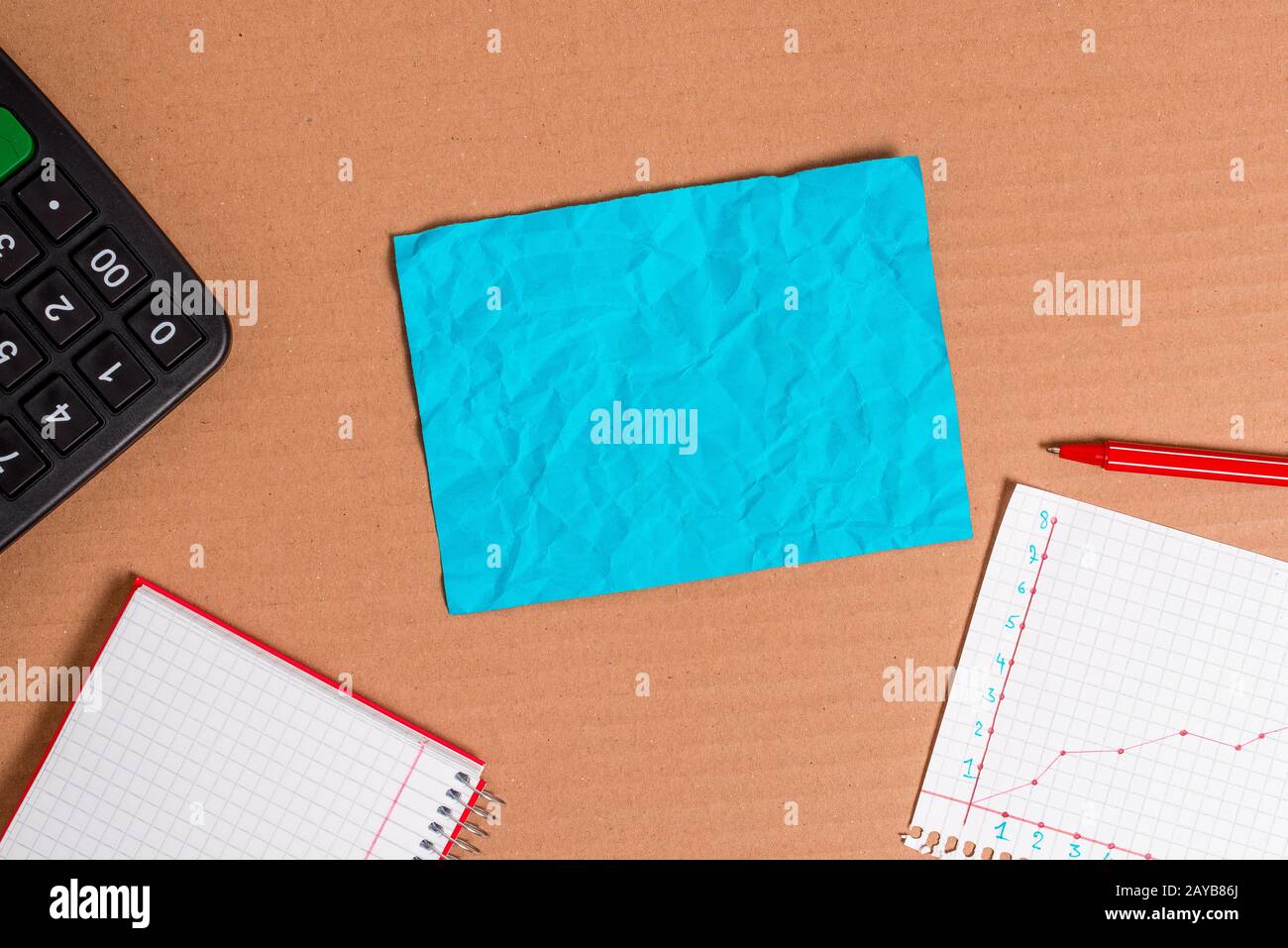 Cardboard desk with notebook paper and office appliances. Paperboard ...