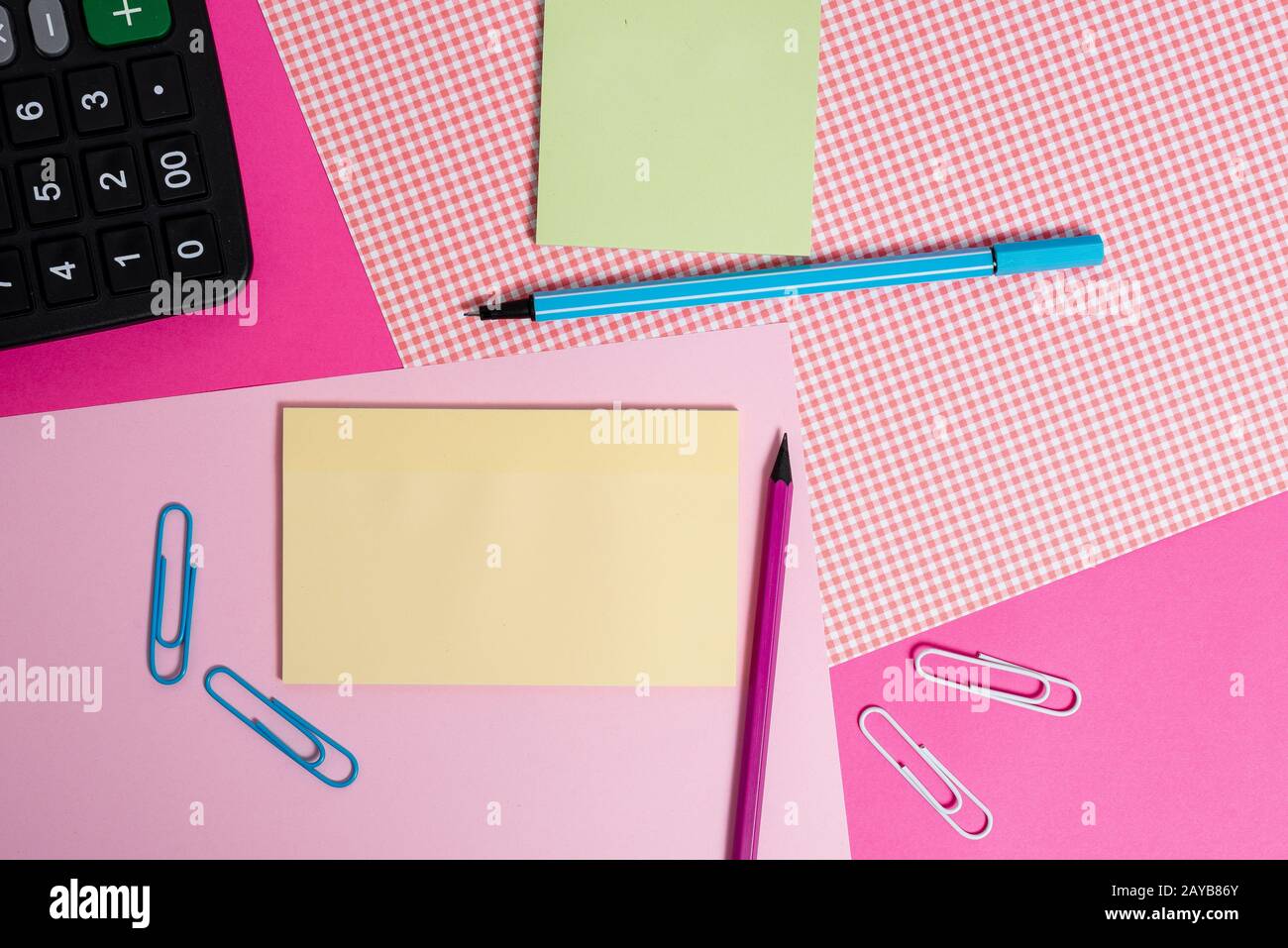 Stationary and notation papers placed above coloured backdrop. Writing ...