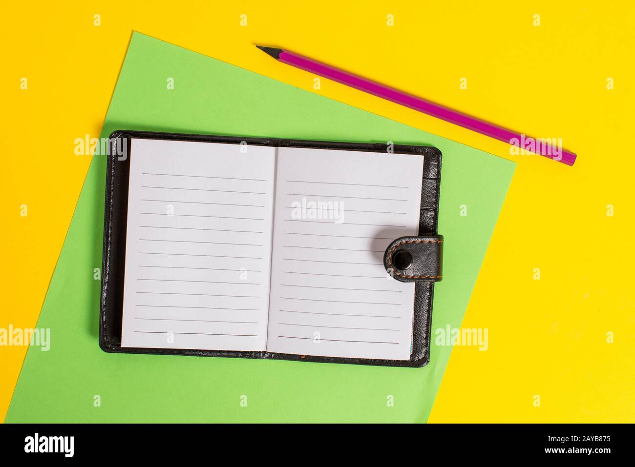 Close front view private dark leather locked diary with striped paper ...