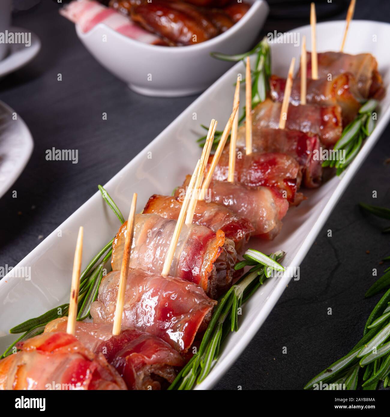 dates wrapped in bacon and delicious tapas Stock Photo - Alamy