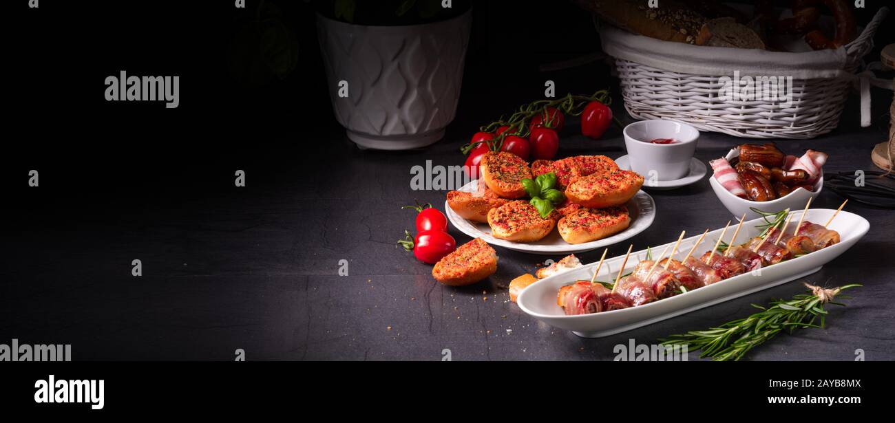 dates wrapped in bacon and delicious tapas Stock Photo - Alamy