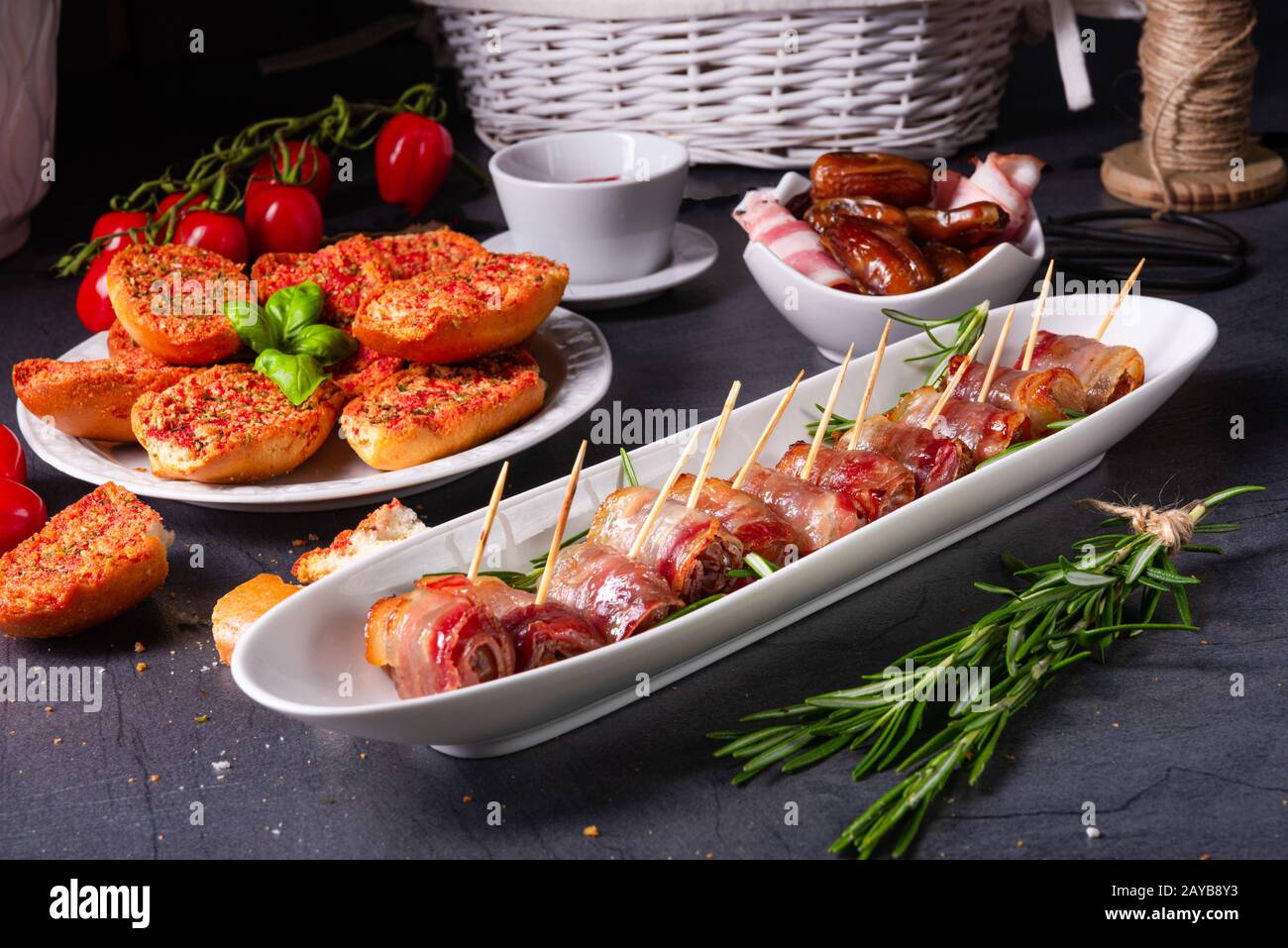 dates wrapped in bacon and delicious tapas Stock Photo - Alamy