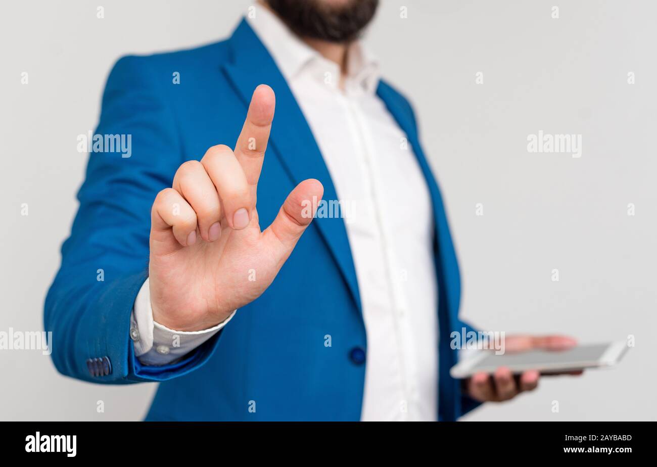 Businessman with pointing finger in front of him. Businessman holds lap ...