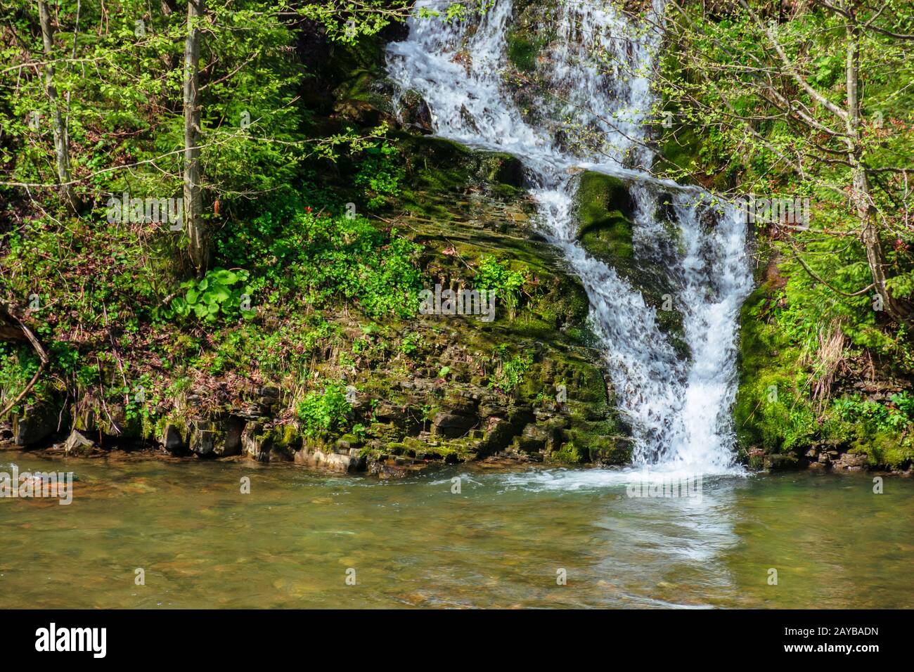 waterfall from the forest on the hill. beautiful nature scenery in ...