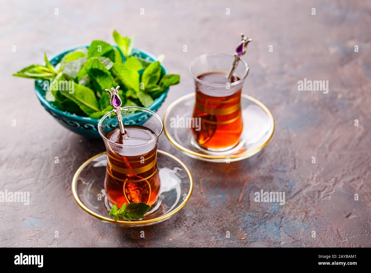 Traditional Turkish arabic dessert and a glass of tea with mint Stock ...