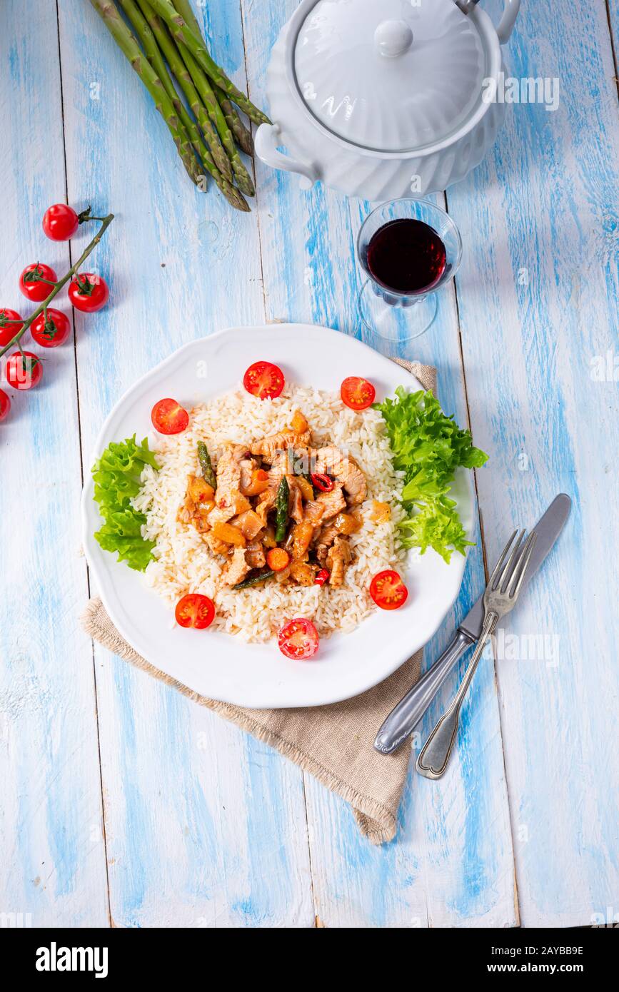 Turkey fricassee on rice with asparagus and paprika Stock Photo - Alamy