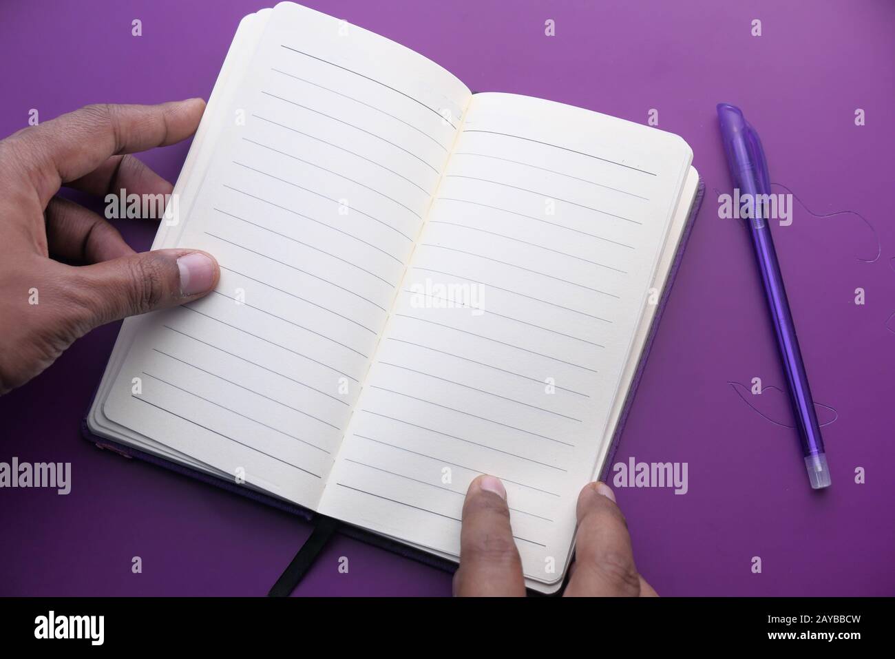 top view of man hand holding notepad Stock Photo - Alamy
