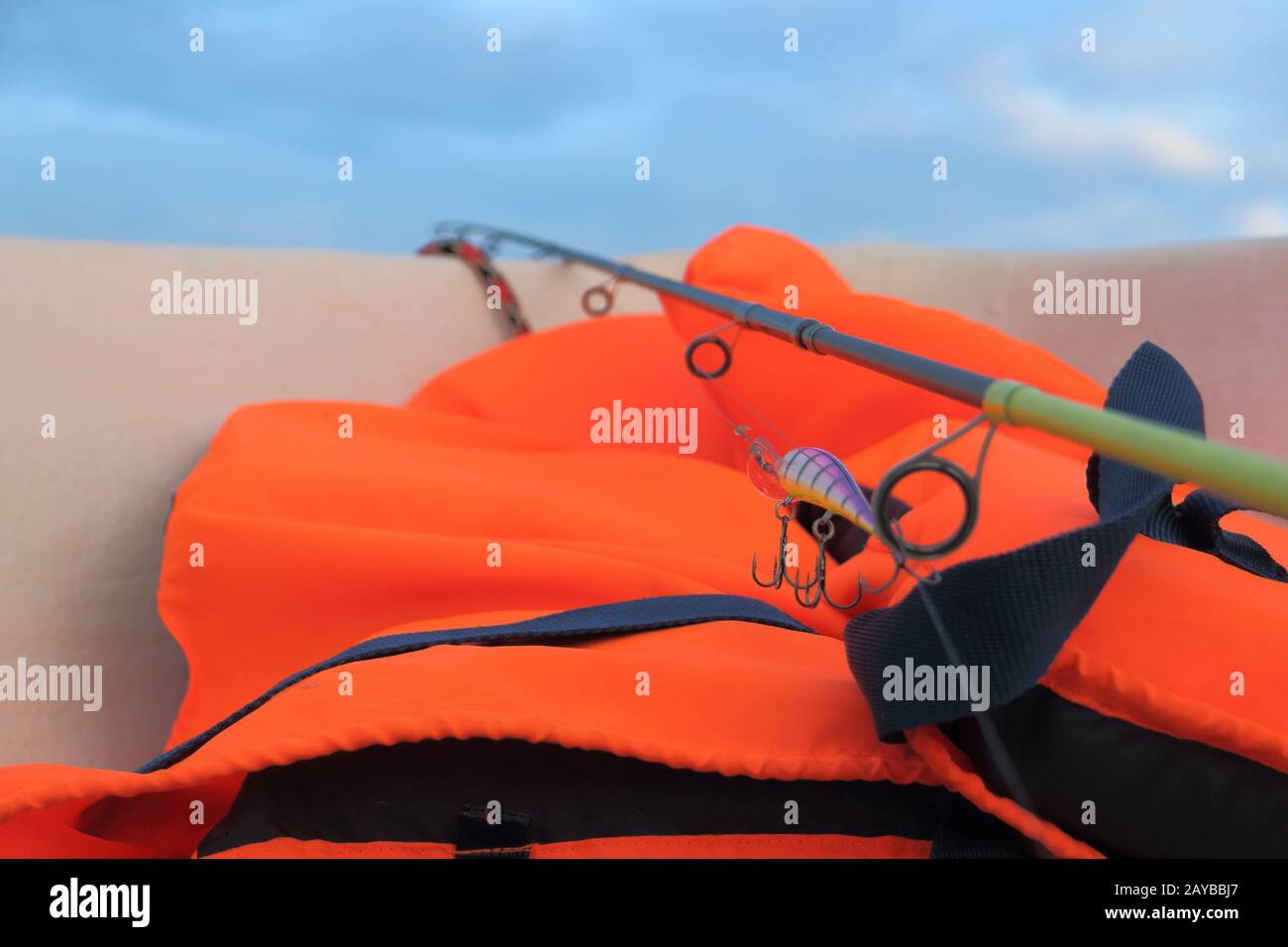 orange life jacket fishing and rod on fishing Stock Photo - Alamy