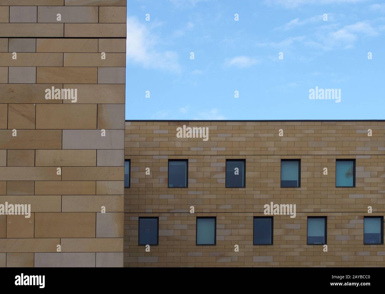 the facade of a modern stone building with geometric repeating pattern ...