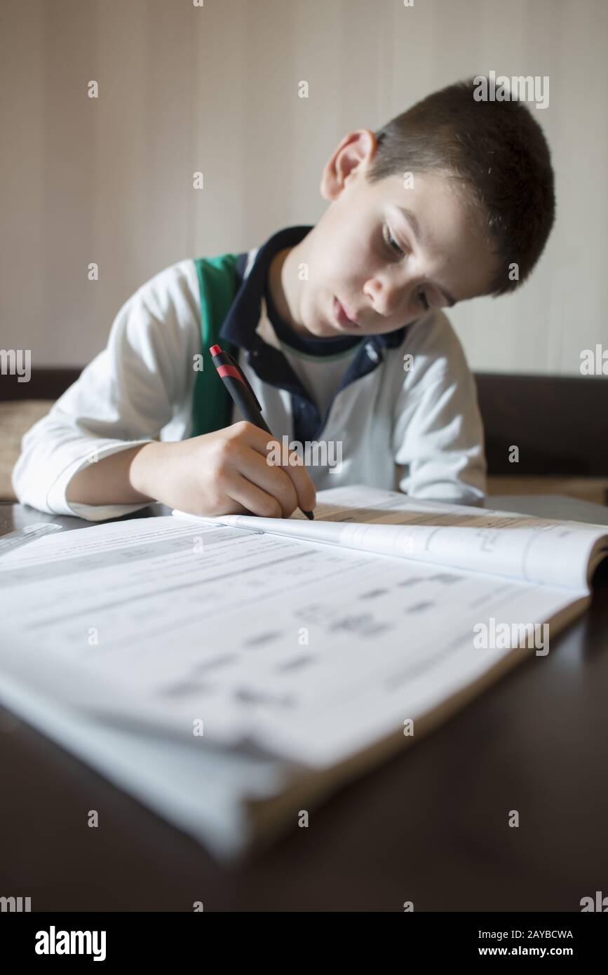 Child do his homework. Hand hold pen. Boy learning Stock Photo - Alamy