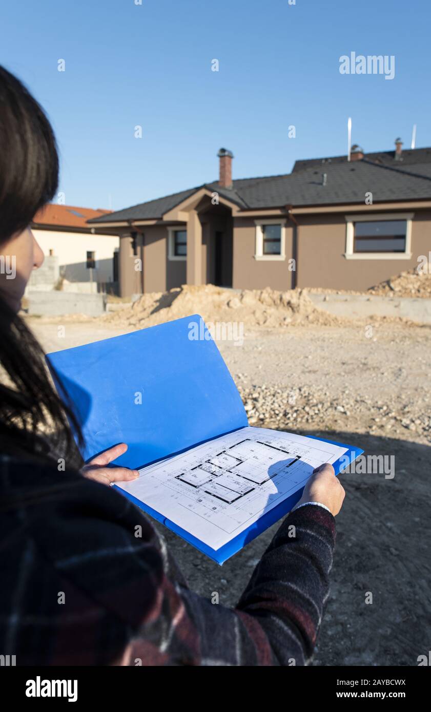 New build house and blueprints Stock Photo - Alamy