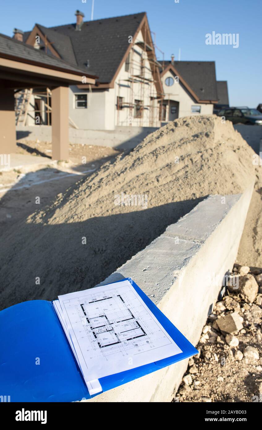 New build house and blueprints Stock Photo - Alamy