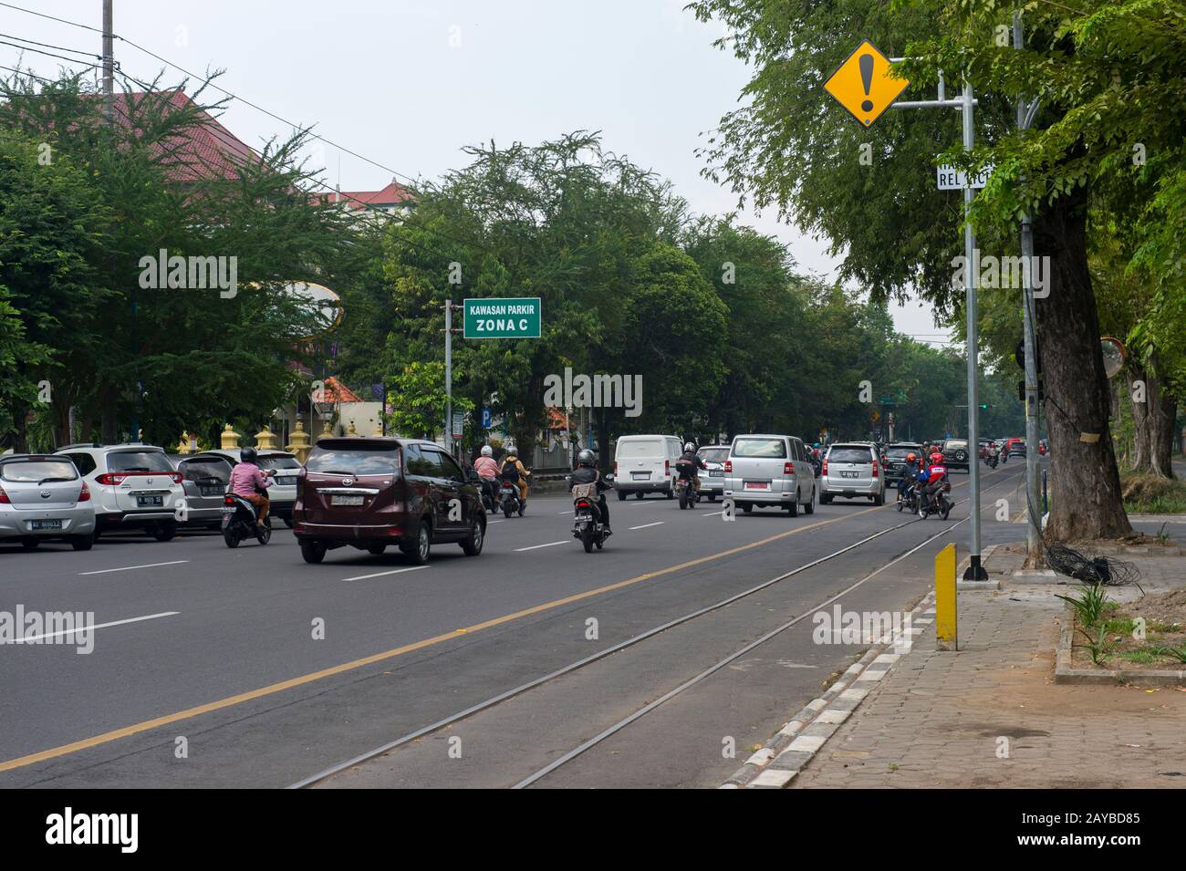 Street scene with cars and mopeds in Solo, a city on Java, Indonesia ...