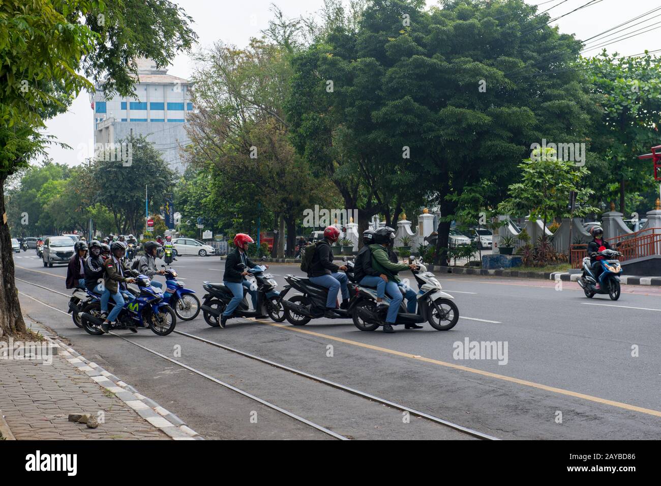 Street scene with cars and mopeds in Solo, a city on Java, Indonesia ...
