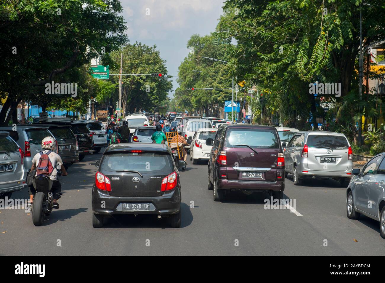 Street scene with cars and mopeds in Solo, a city on Java, Indonesia ...