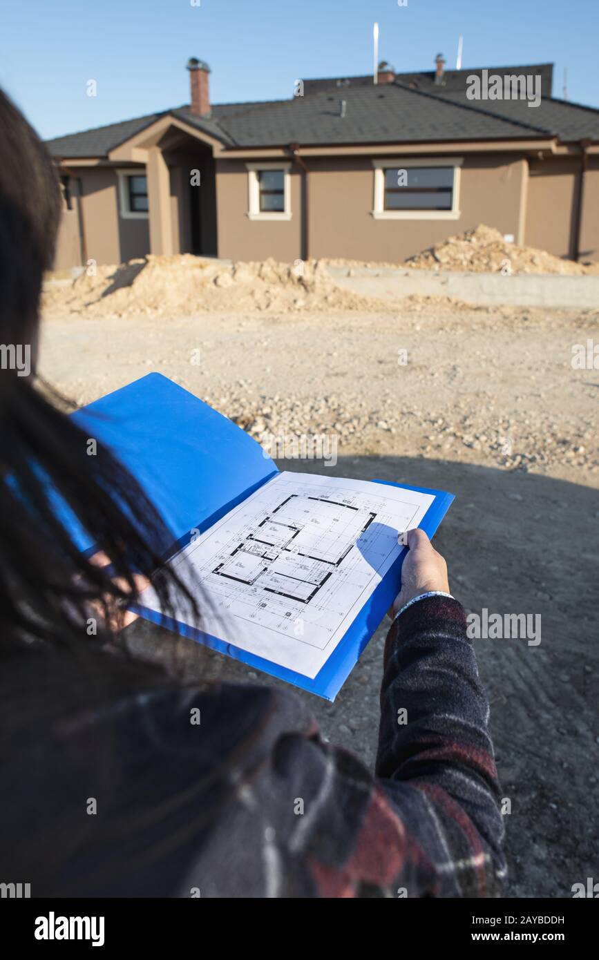 New build house and blueprints Stock Photo - Alamy