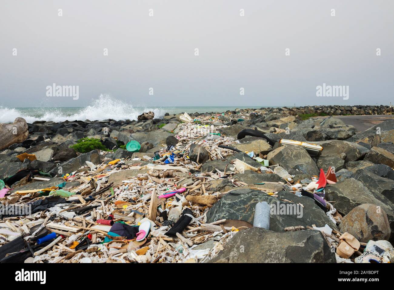 Spilled garbage on the beach near the big city. Empty used dirty ...