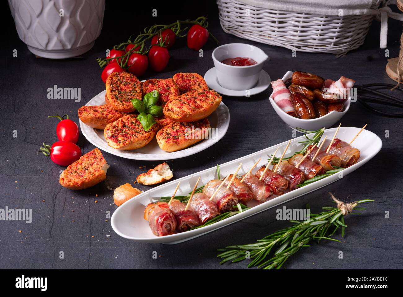 dates wrapped in bacon and delicious tapas Stock Photo - Alamy