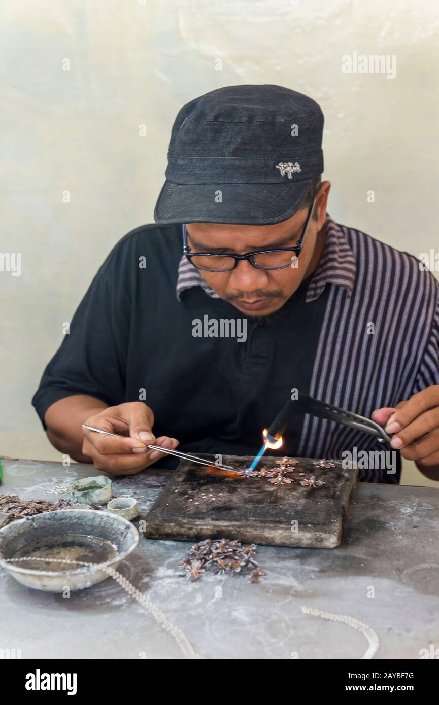 A man working at a silversmith making silver jewelry in Yogyakarta in ...
