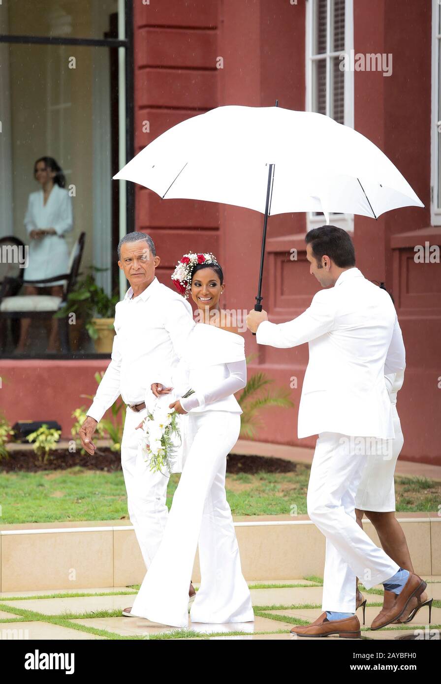 PORT OF SPAIN, TRINIDAD - FEB 14: Renee Butcher is escorted by her ...
