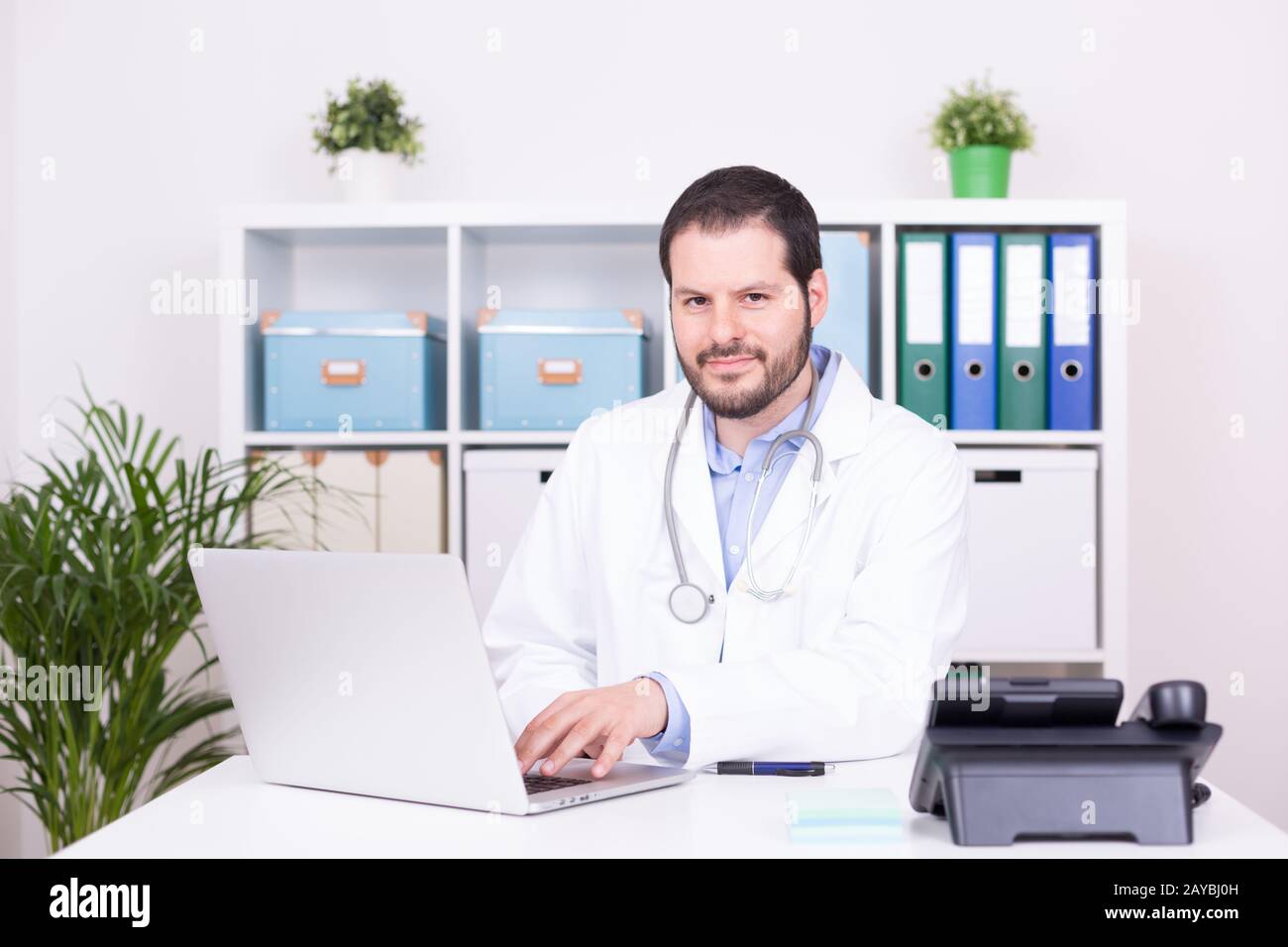 Bearded doctor working at his office. Business and medical concept ...