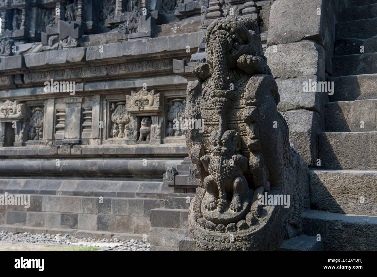 Guardian figures at the bottom of steps of a temple in the Prambanan ...