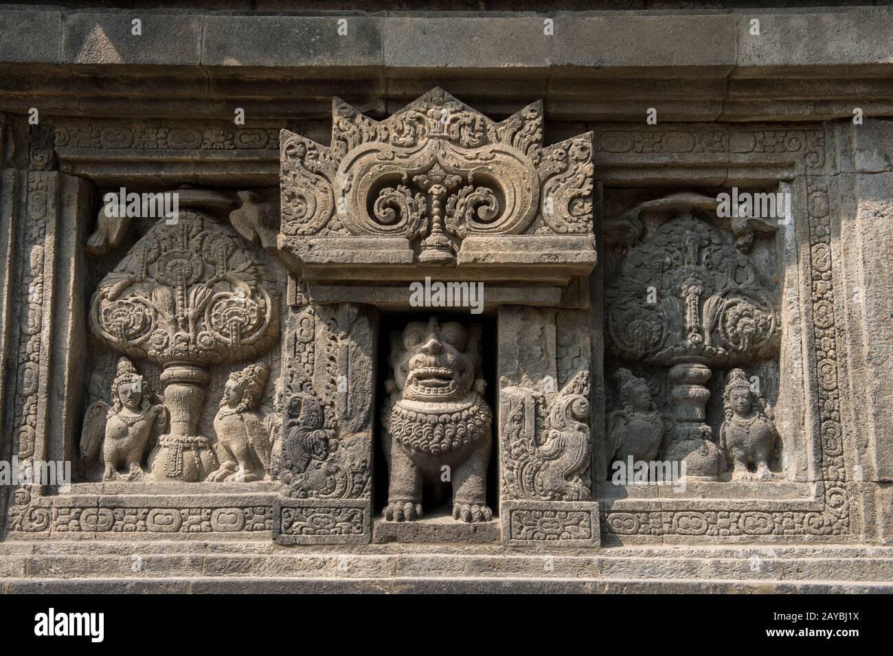 Bas relief stone carving of a lion flanked by kalpataru trees at the ...