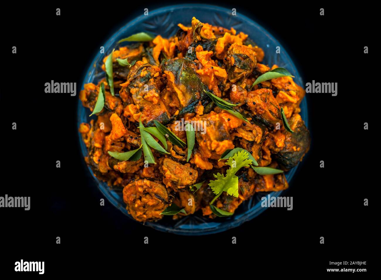 Famous Indian & Gujarati snack dish in a glass plate on wooden surface ...