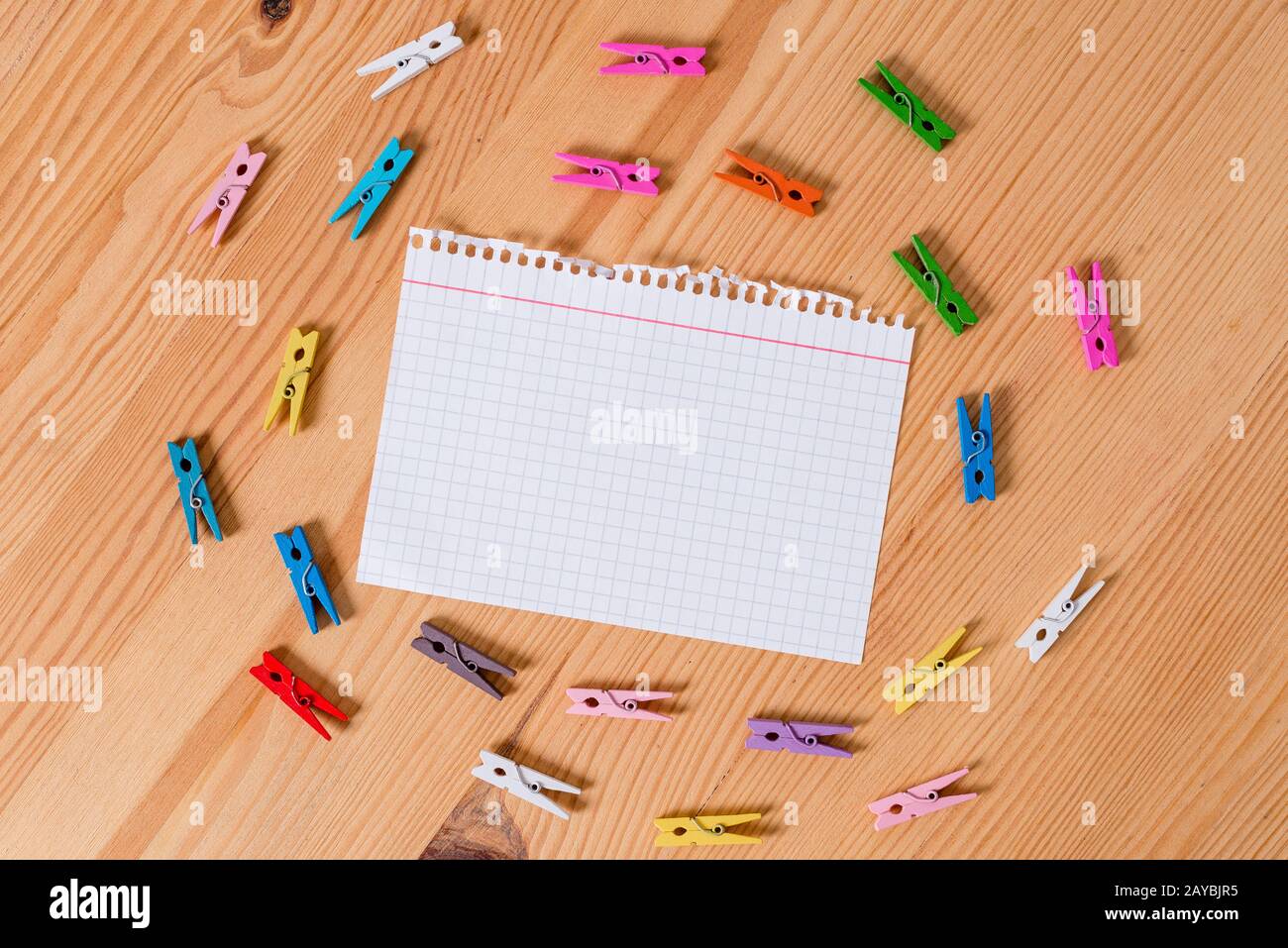 Colored clothespin spread in circles around an empty rectangle square ...