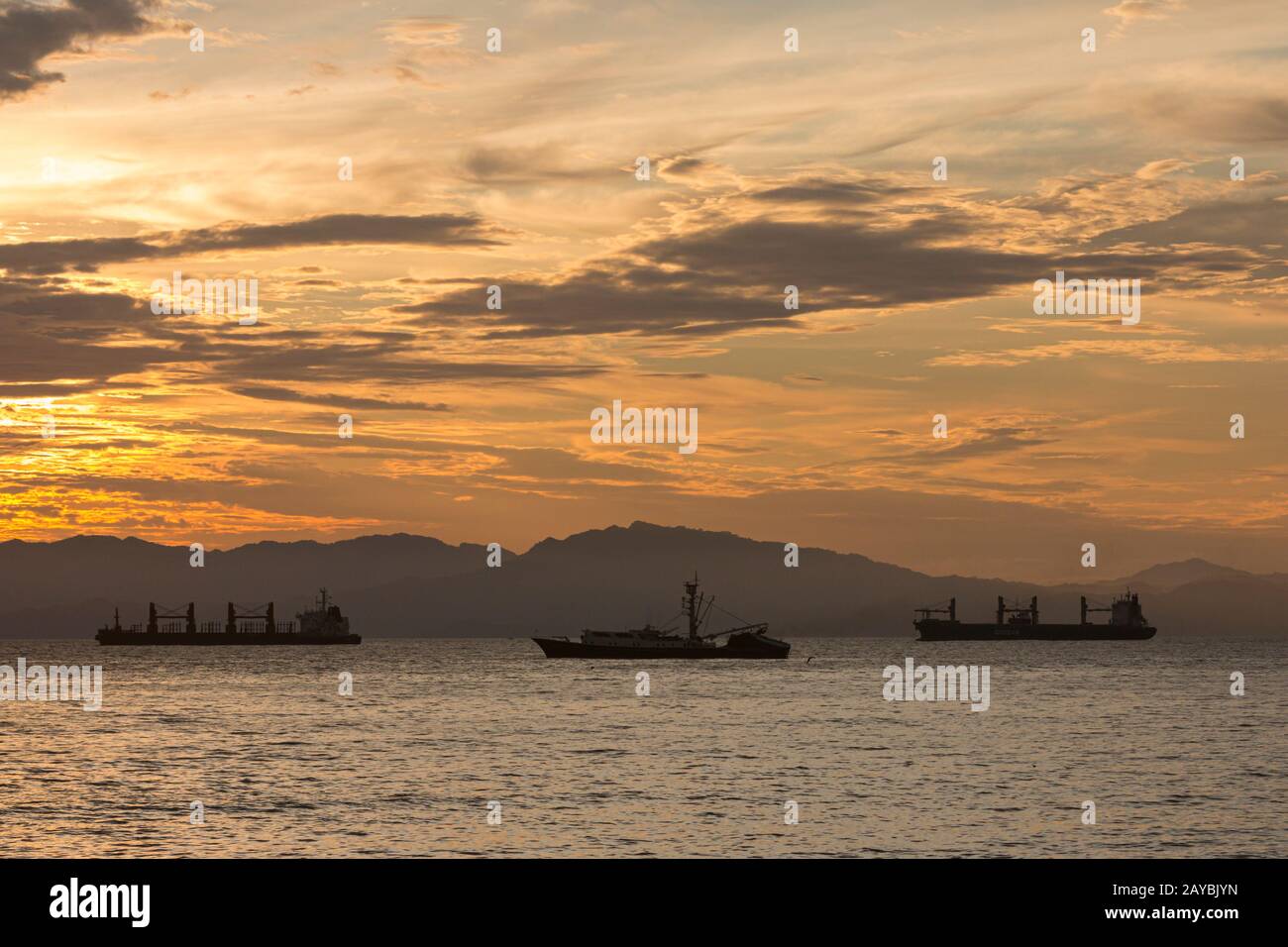 Boats waiting to enter the Port of Caldera, during a sunset. Main port ...