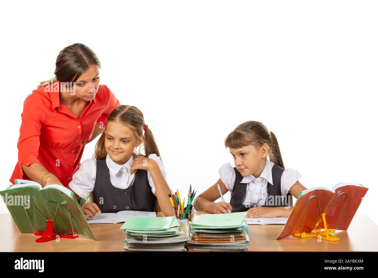 The teacher helps to understand the task of the student Stock Photo - Alamy