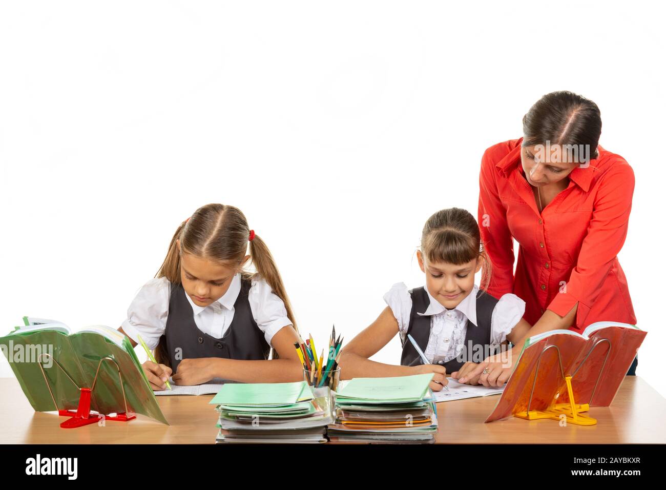 The teacher goes around the students, looks in the notebook, the ...