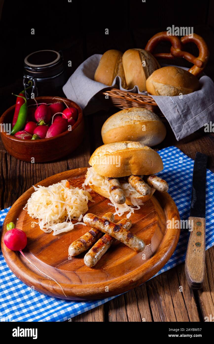 rustic Thuringian bratwurst with sauerkraut and roll Stock Photo - Alamy