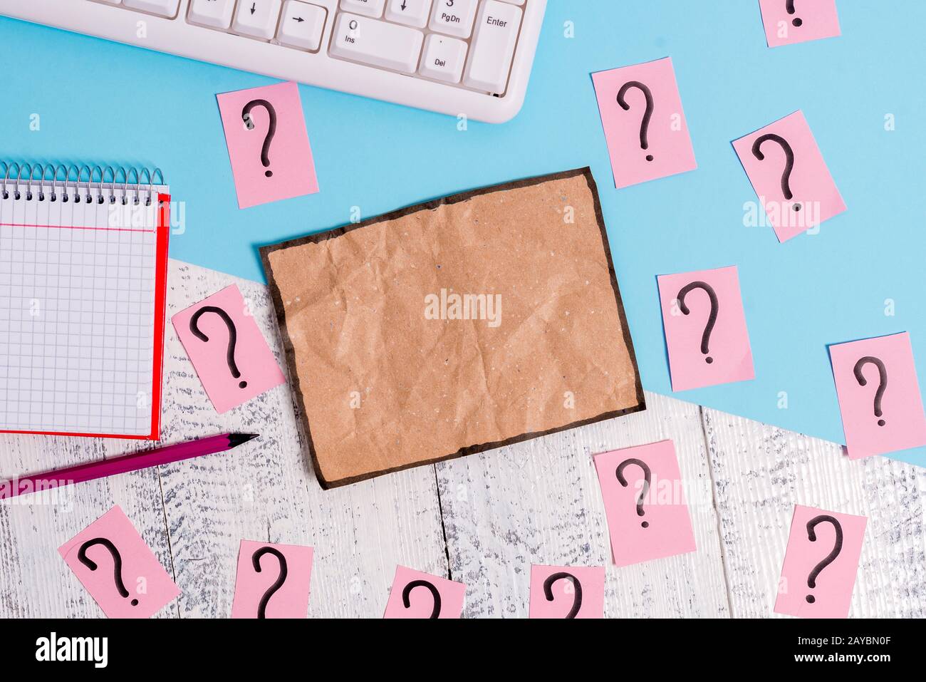 Writing equipment and computer stuff plus scribbled paper placed on a ...