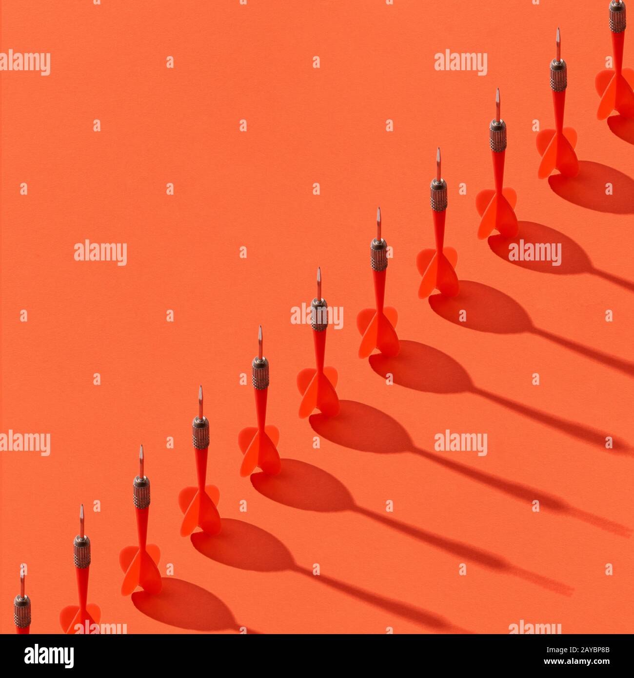 Diagonal line of darts with shadows Stock Photo - Alamy